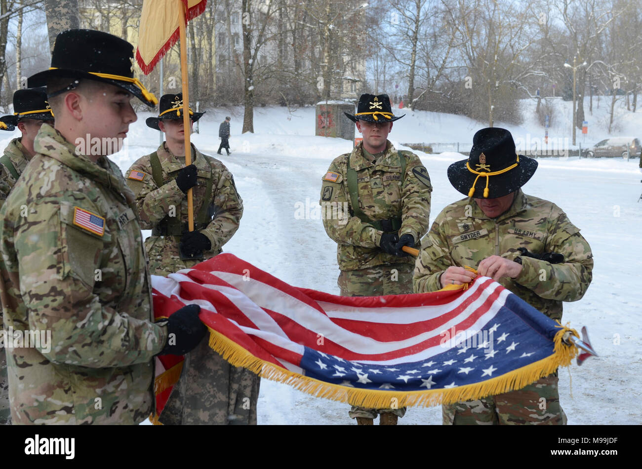 Spc. Ryan Christy holds the United States flag as Command Sgt. Maj ...
