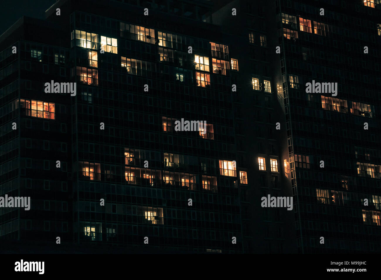 a facade of a building with windows with blue and yellow light in them ...