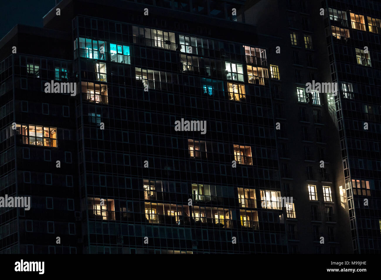 a facade of a building with windows with blue and yellow light in them ...