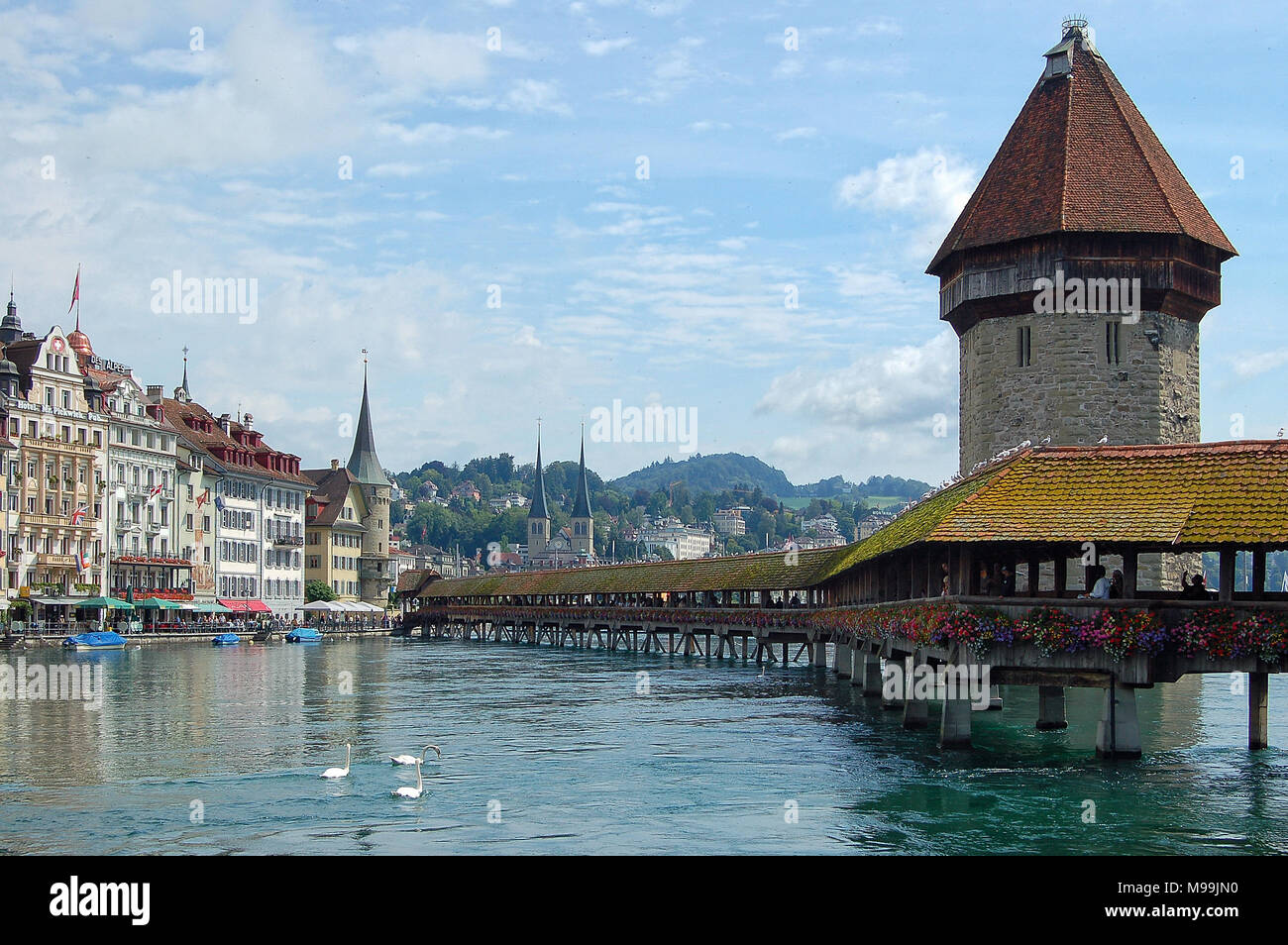 The famous Chapel Bridge (Kapellbrücke) is a covered wooden footbridge ...