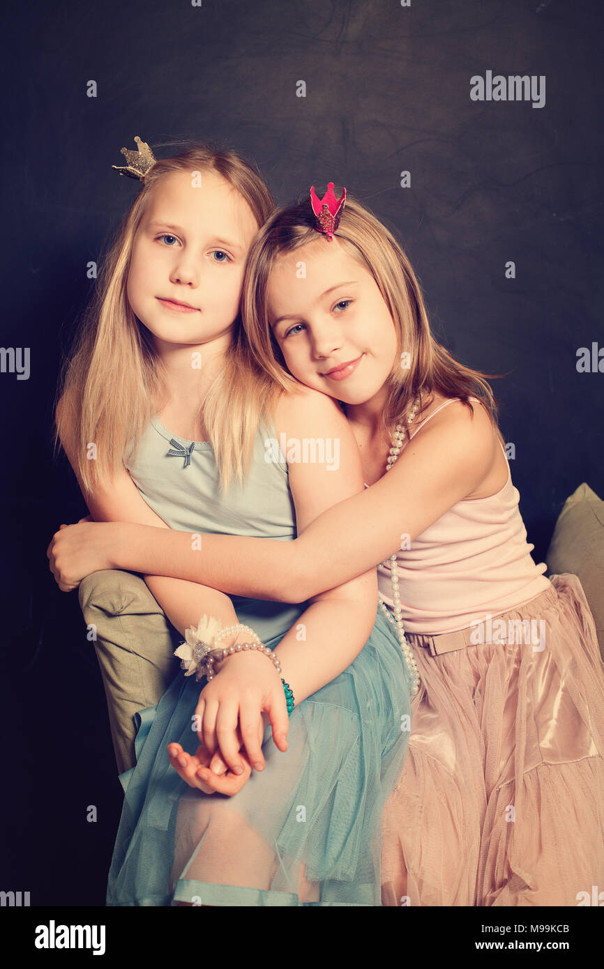 Little sisters girls hugging Stock Photo - Alamy