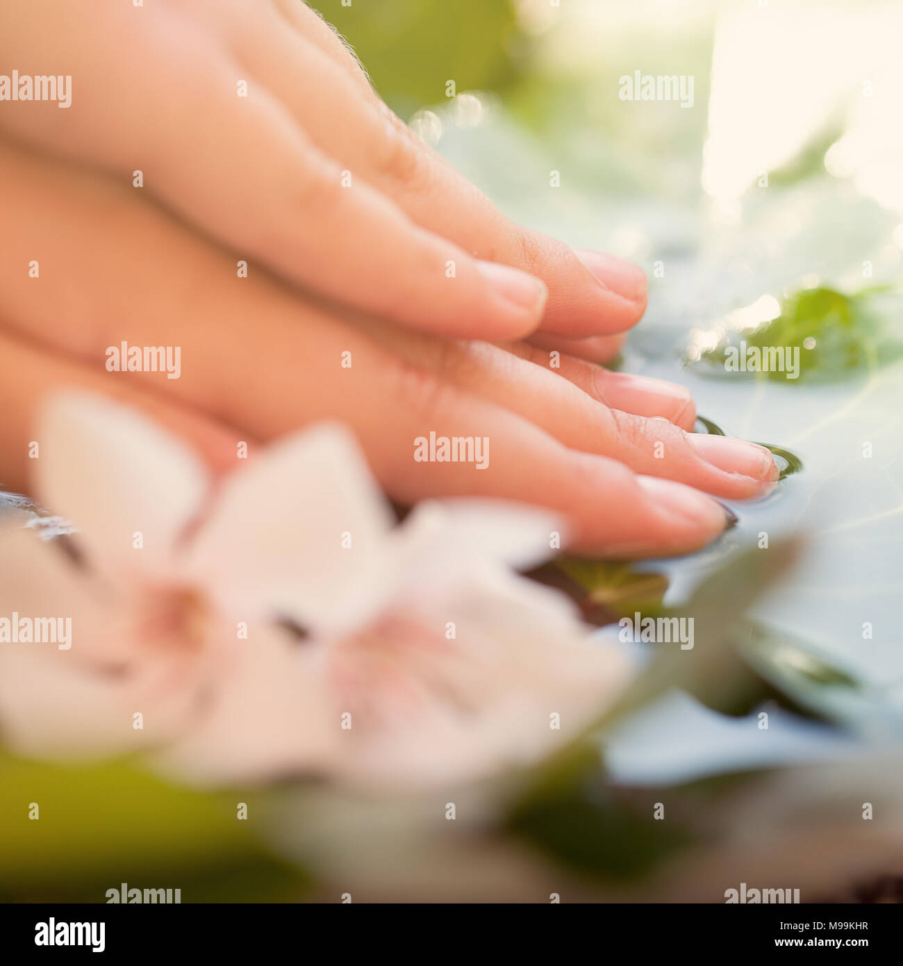 Manicure background with hand and water Stock Photo - Alamy