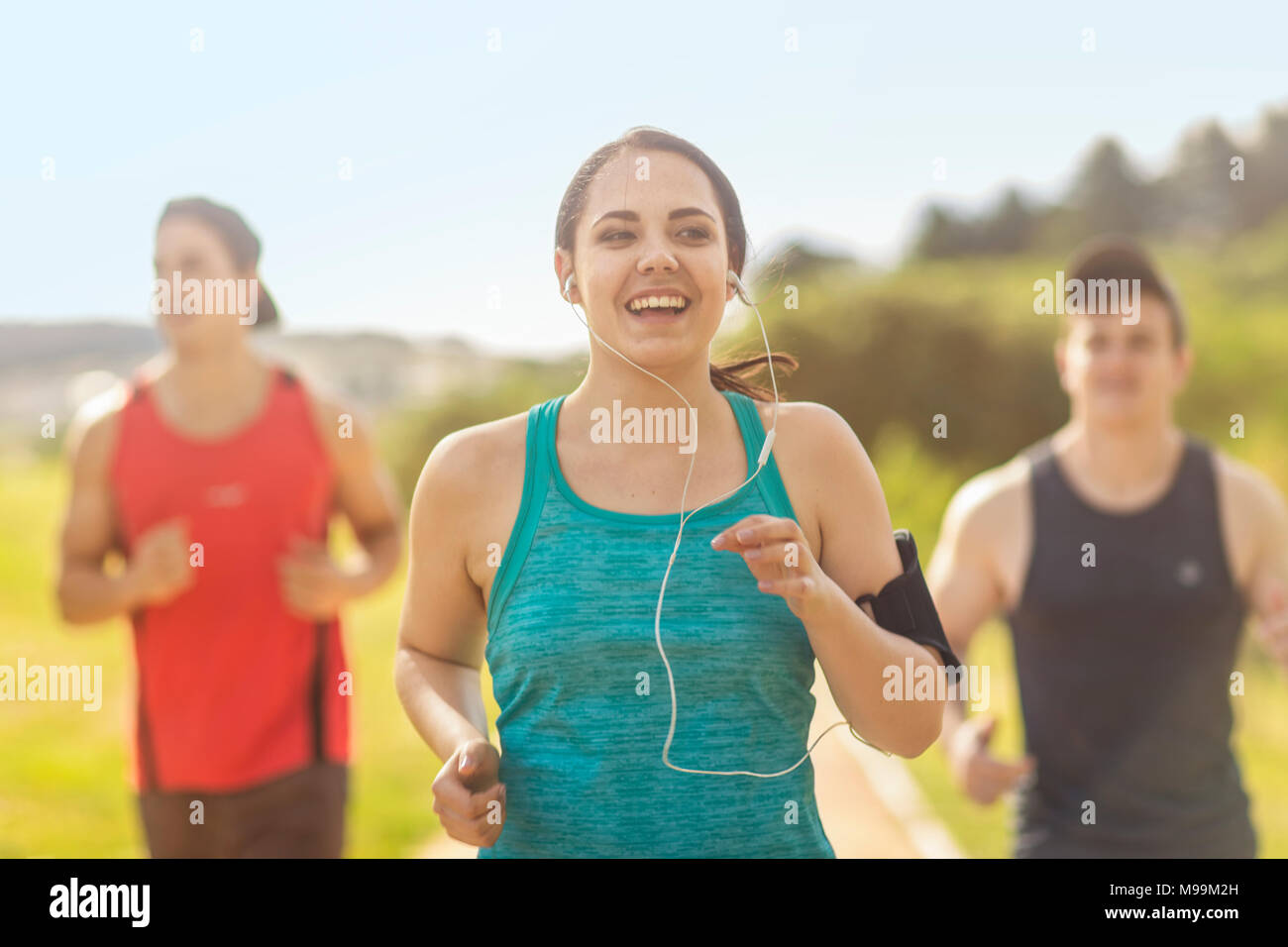 Group of friends running together Stock Photo - Alamy