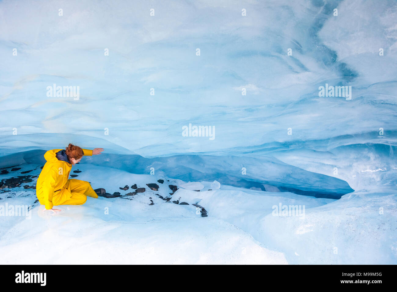 USA, Alaska, Valdez, Valdez Glacier young woman wearing oilskin ...