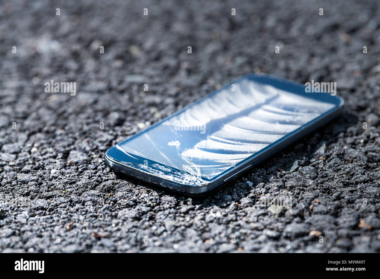Asphalt pavement road with broken phone smartphone, cracked screen fell ...