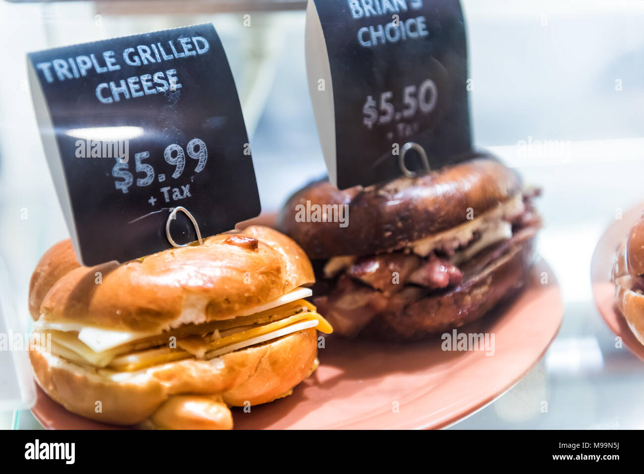 Triple grilled cheese bagel sandwich sign with prices on display with ...