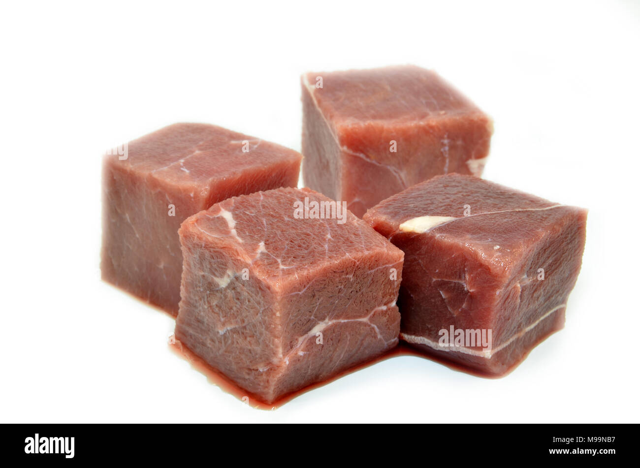 Diced or cubed raw beef steak isolated on white background Stock Photo ...