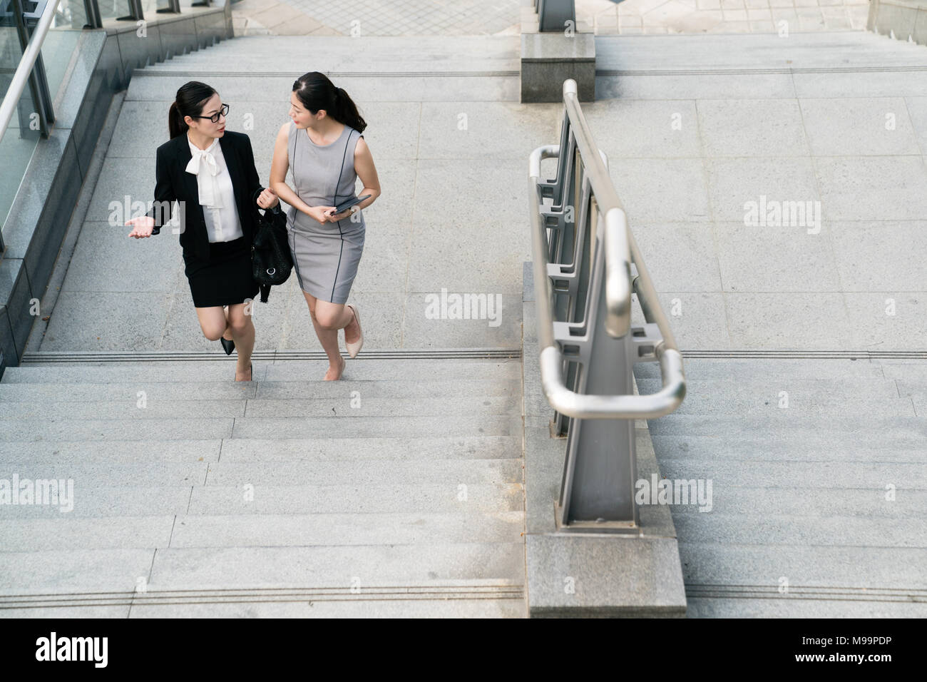 One business lady is introducing to an office lady supervisor boss ...