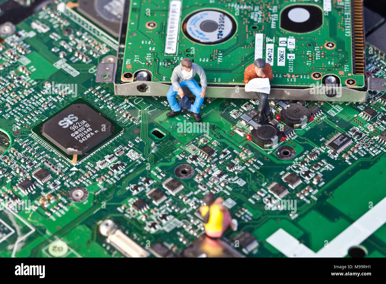 Macro picture of computer electronics with people sitting Stock Photo ...
