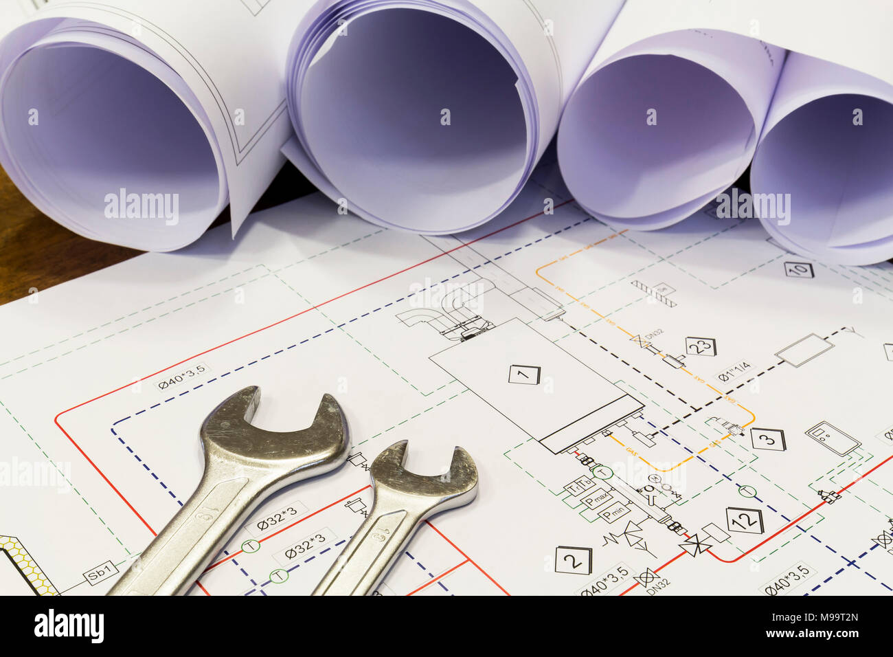 Maintenance and service: Wrench and project drawings with plumbing ...