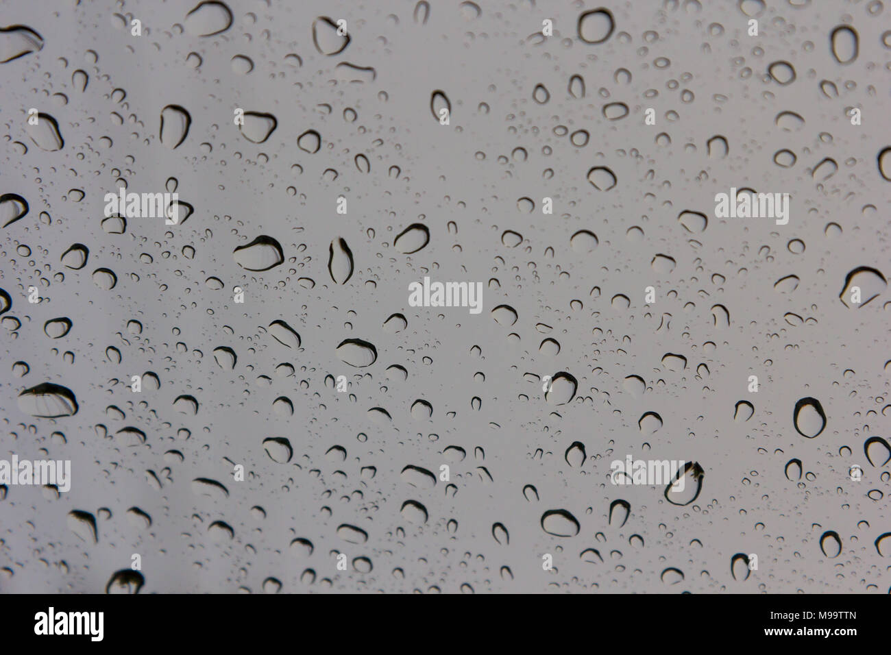 Water drops on glass raining day Stock Photo - Alamy