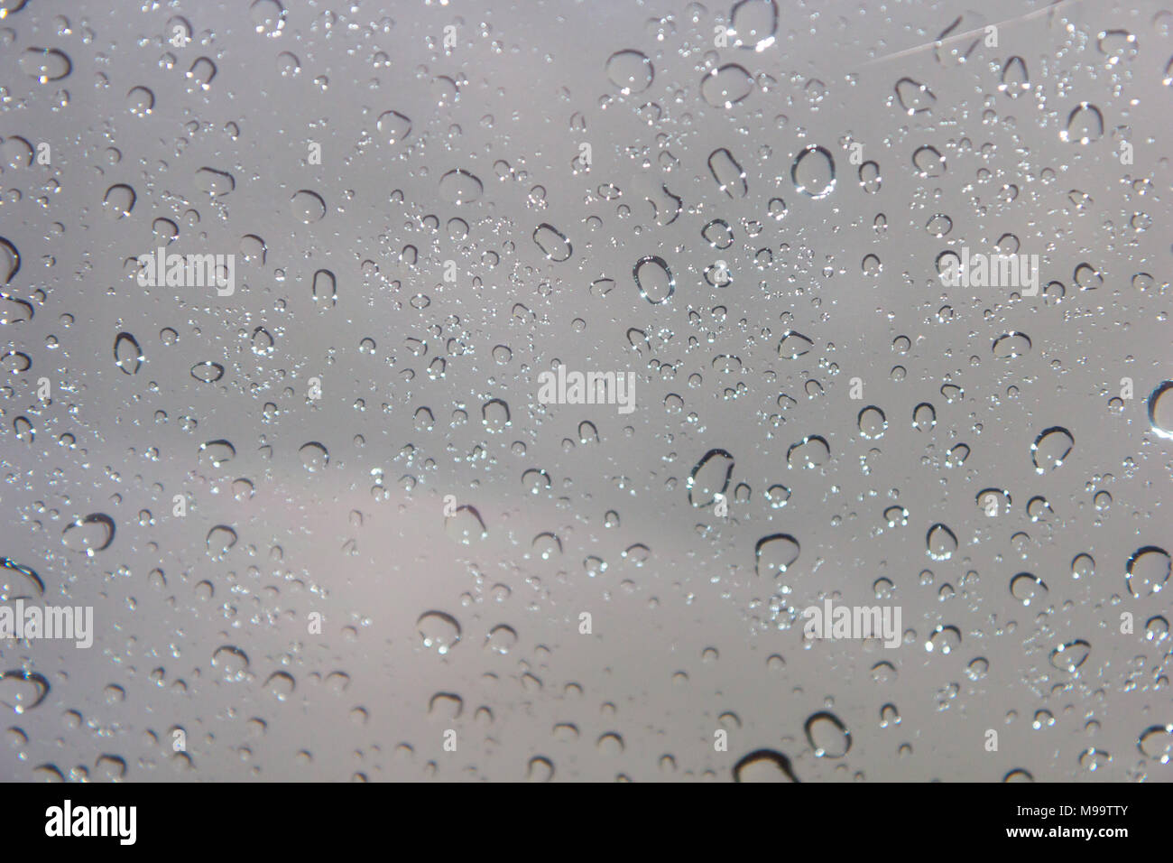 Water drops on glass raining day Stock Photo - Alamy
