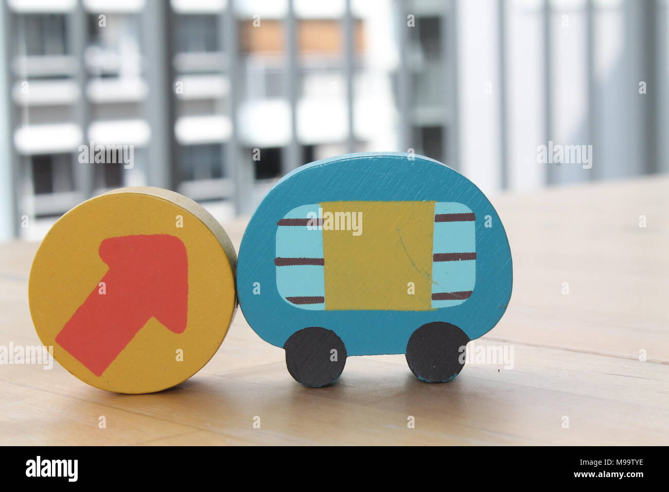 Wooden toy cars with arrow on the circle on the table Stock Photo - Alamy