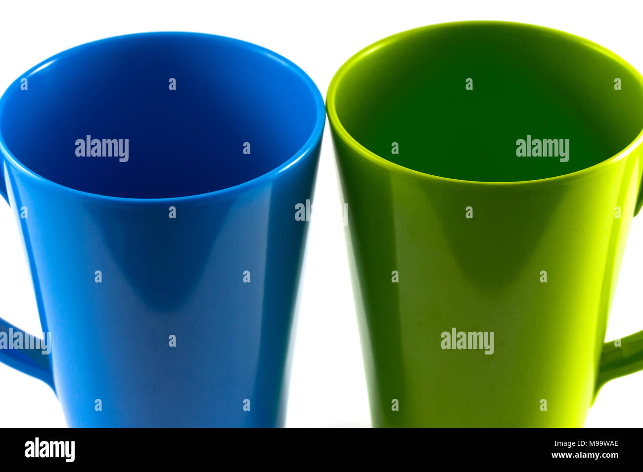 Green and blue cup isolate on white background Stock Photo - Alamy