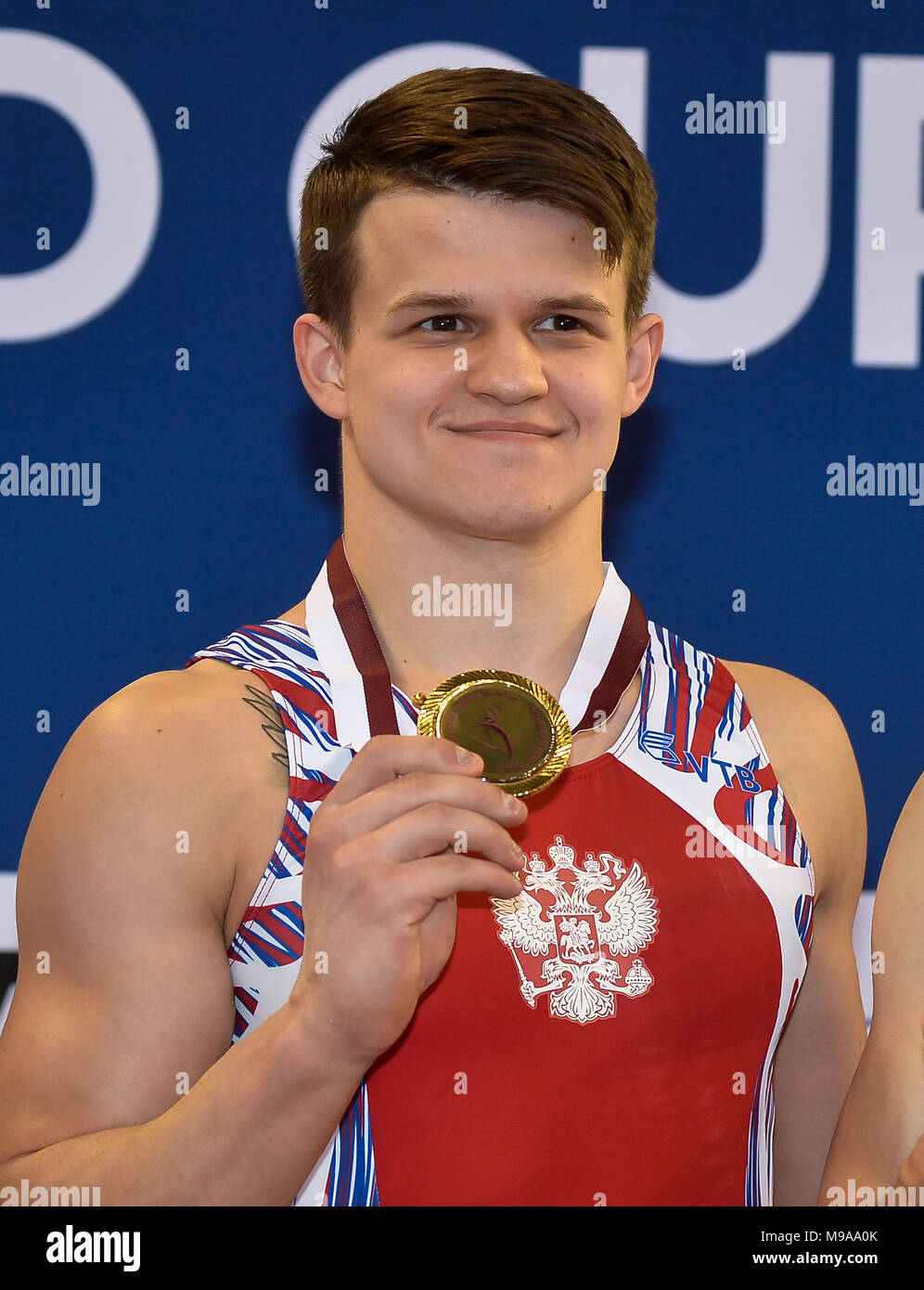Doha, Qatar. 23rd Mar, 2018. Dmitrii Lankin of Russia shows his gold ...