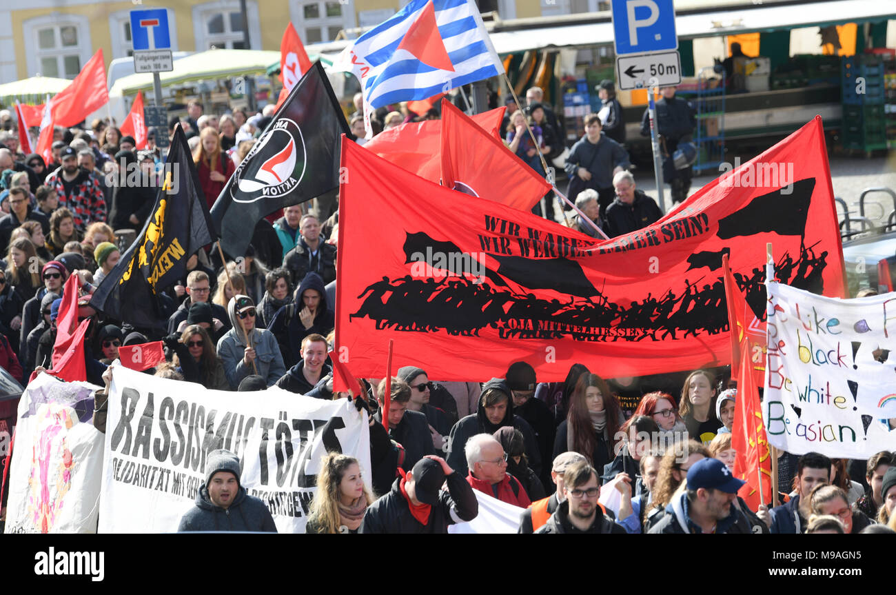 24 March 2018, Germany, Wetzlar: Protesters carrying flags and banners ...