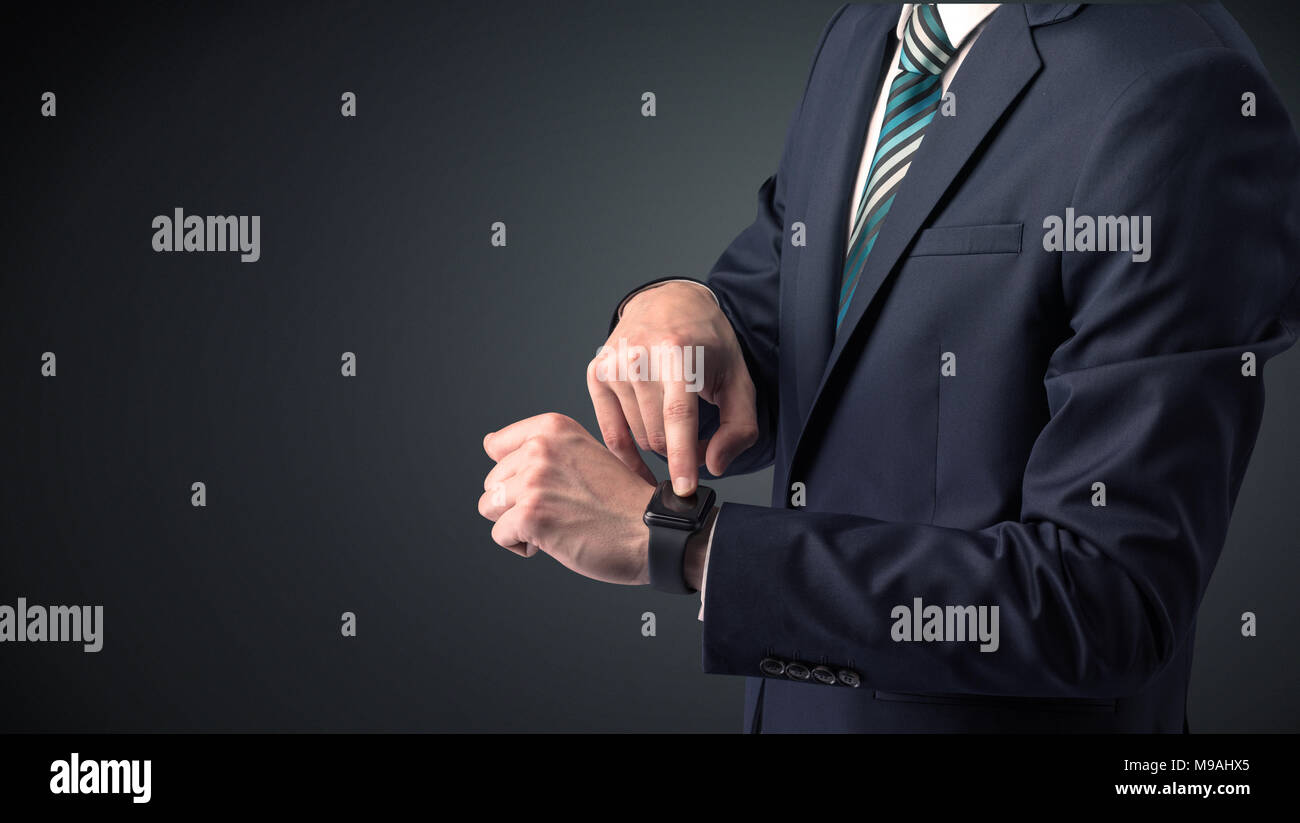 Man wearing suit with smartwatch on his wrist Stock Photo - Alamy