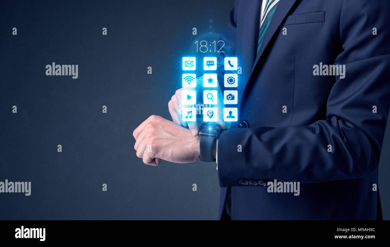 Businessman wearing smartwatch with application icons Stock Photo - Alamy