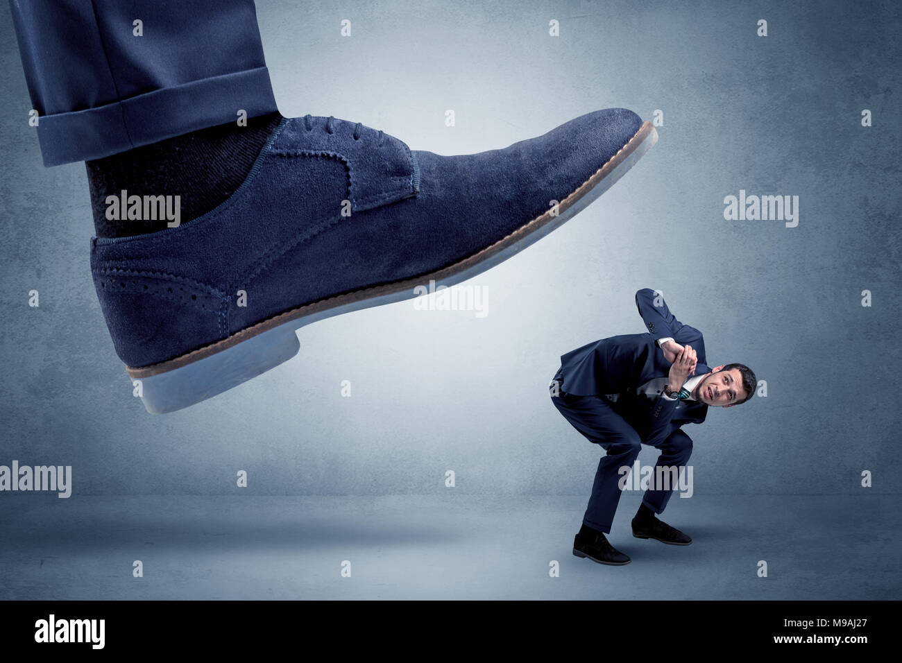 Big foot trying to crush small man who is afraid of that Stock Photo ...