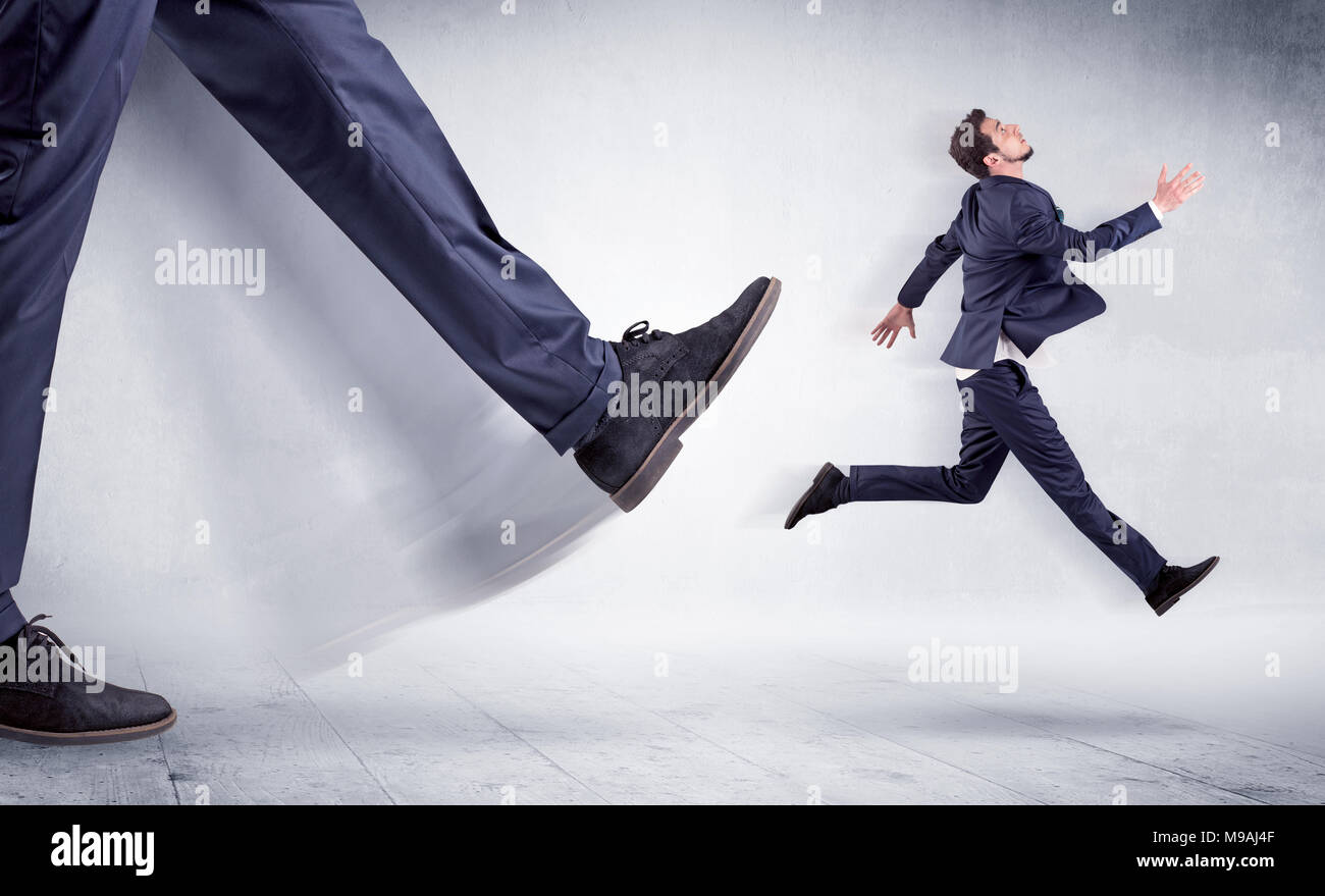 Giant leg kicking small businessman and he is flying away Stock Photo ...