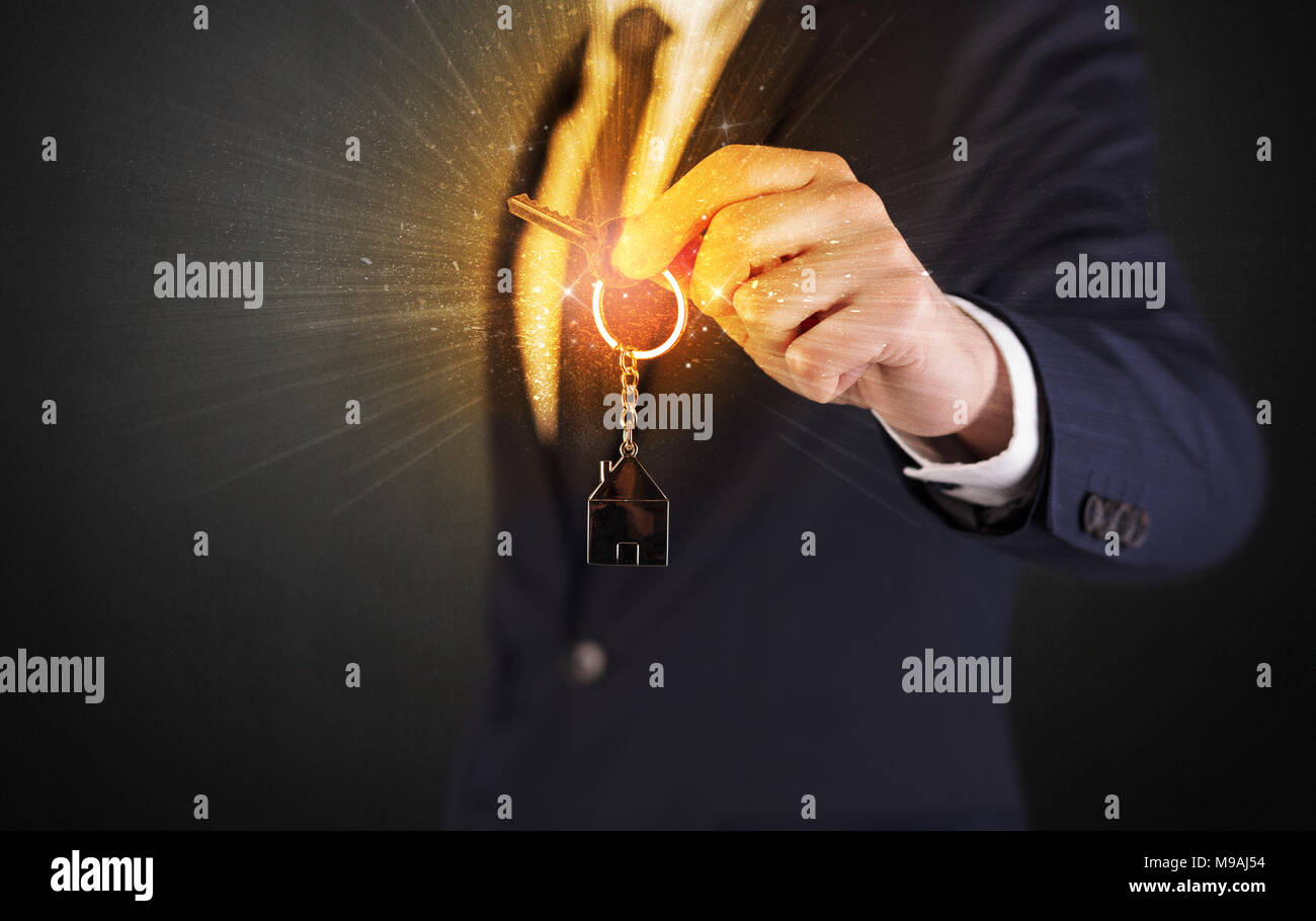 Formal man hand over shiny keys with dark background Stock Photo - Alamy