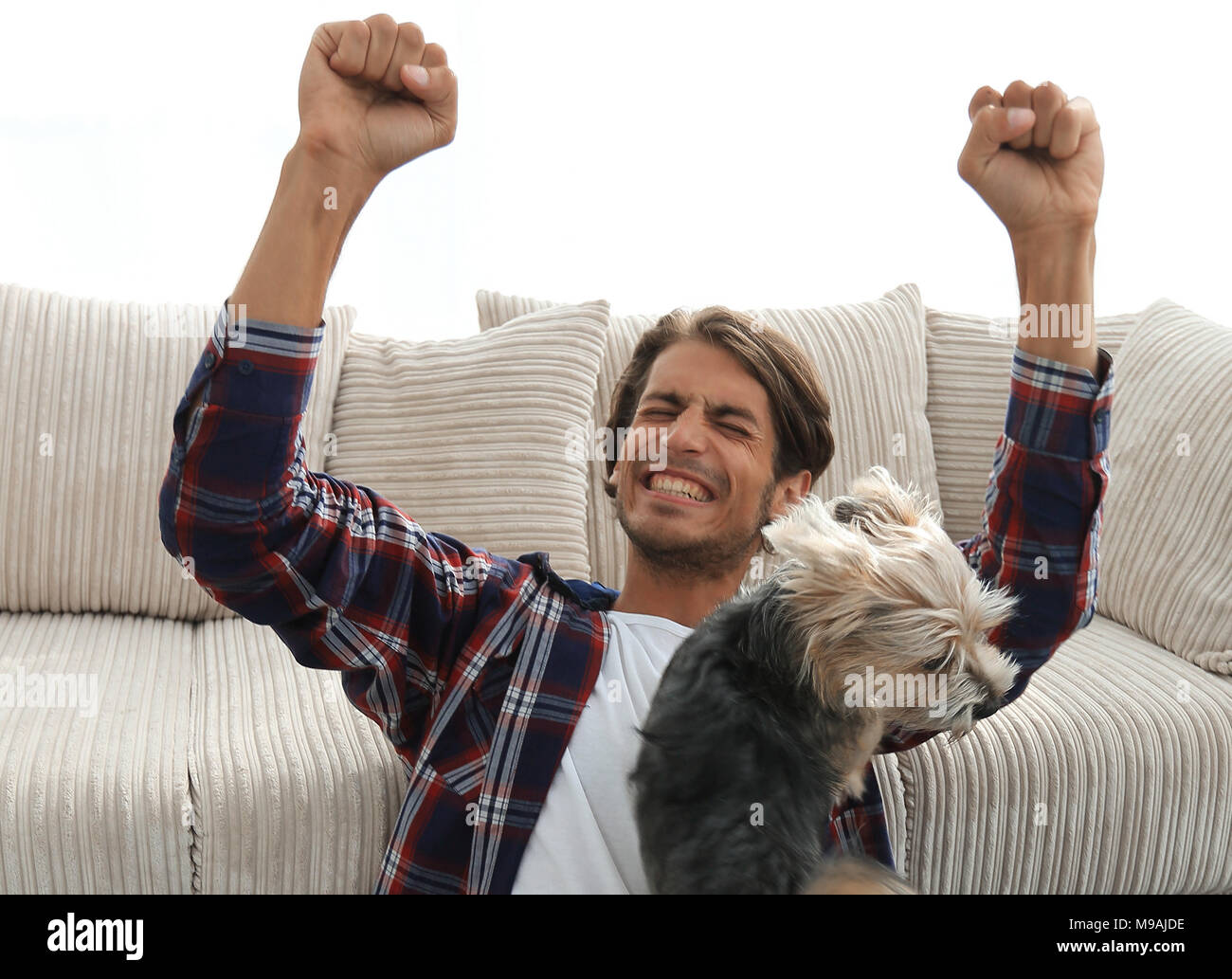 happy guy with laptop jubilant in spacious living room Stock Photo - Alamy