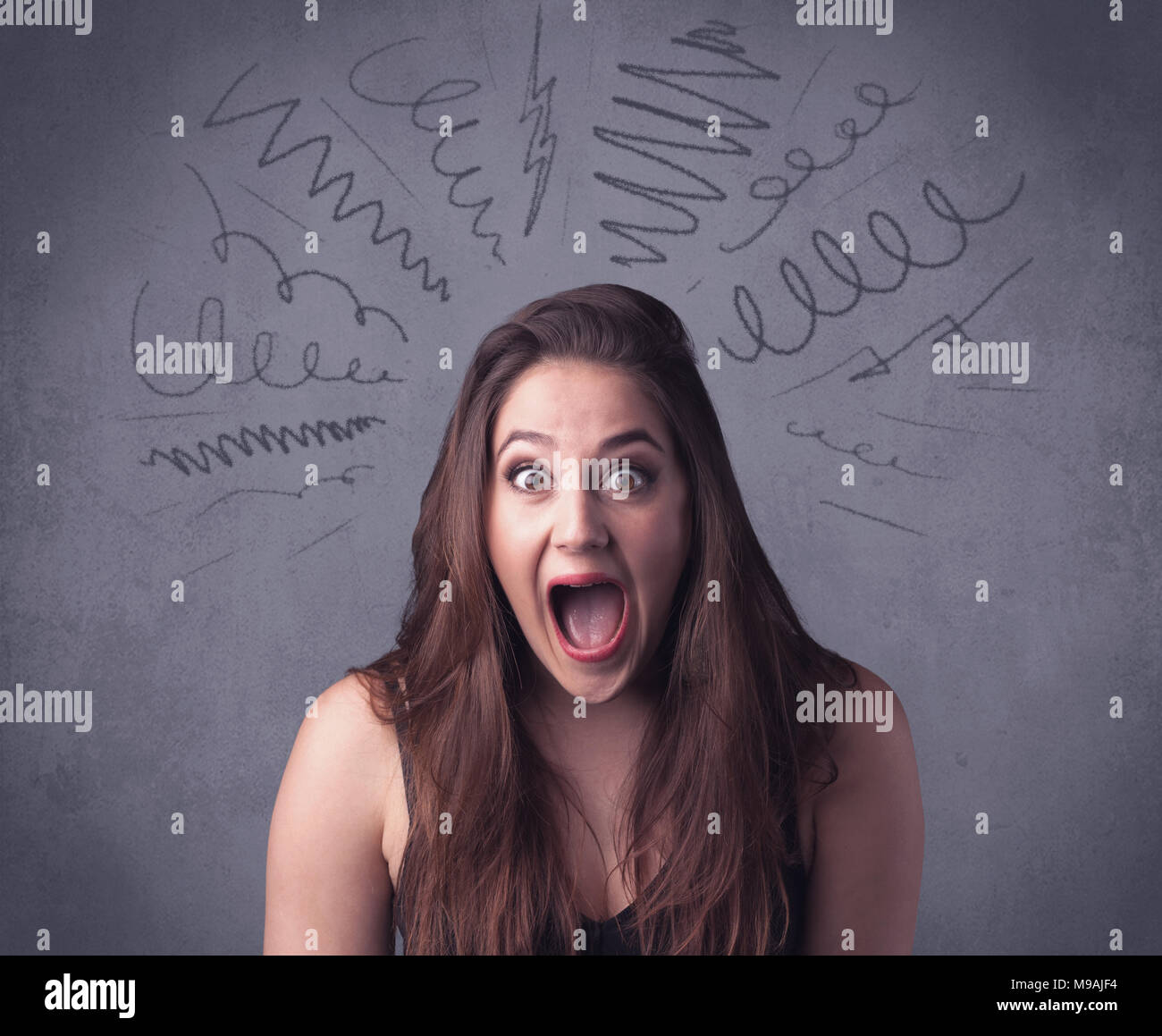 A cute female student making funny face expressions with pressure and ...