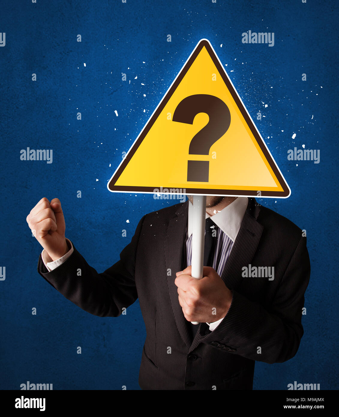 Smart businessman holding yellow sign with question mark Stock Photo ...