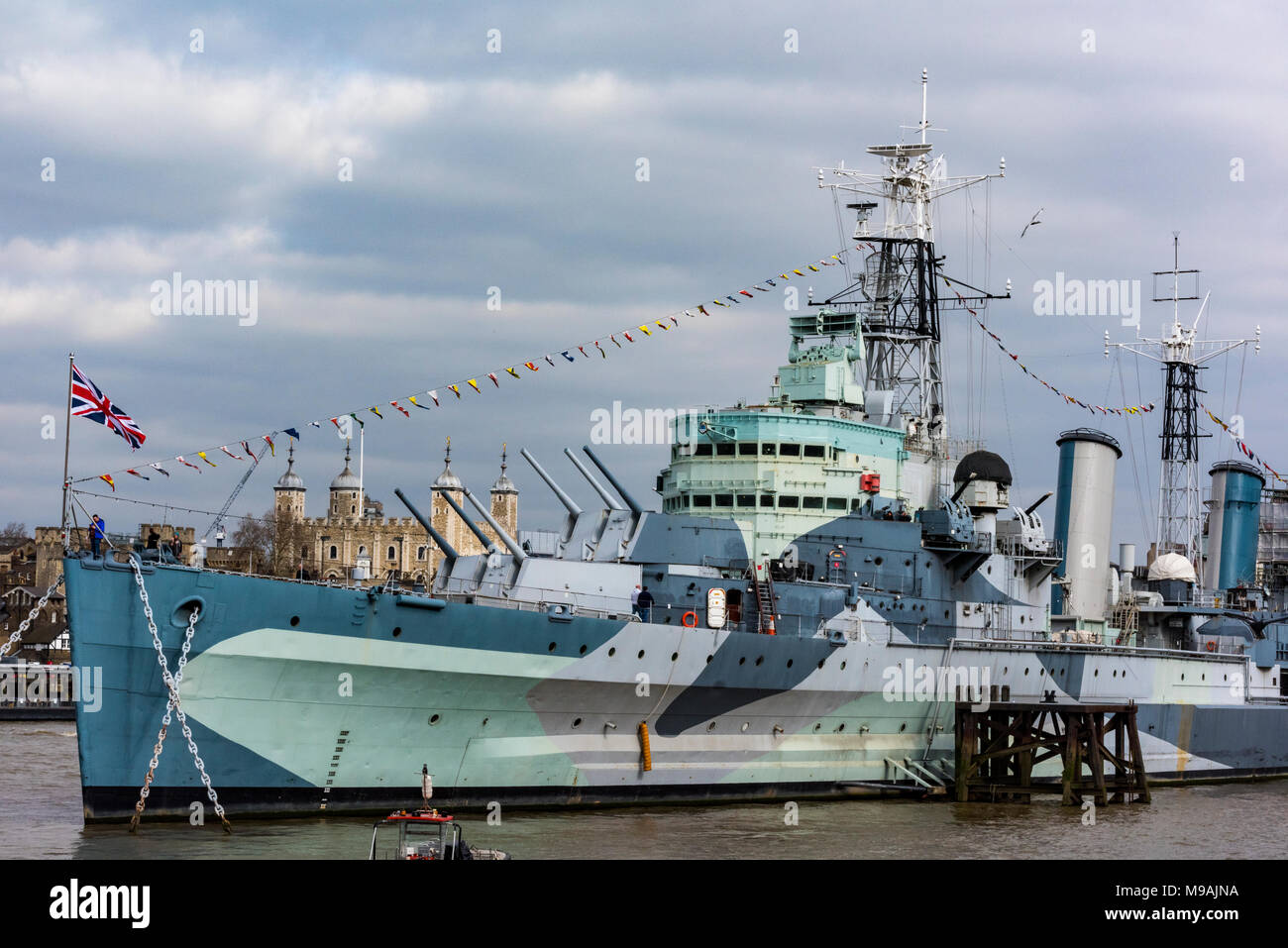 HMS Belfast moored on the side of the river thames in central london at ...
