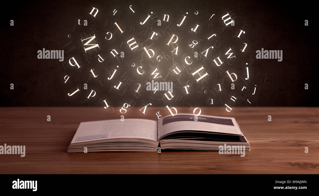 Glowing white alphabet letters coming out of an open book Stock Photo ...