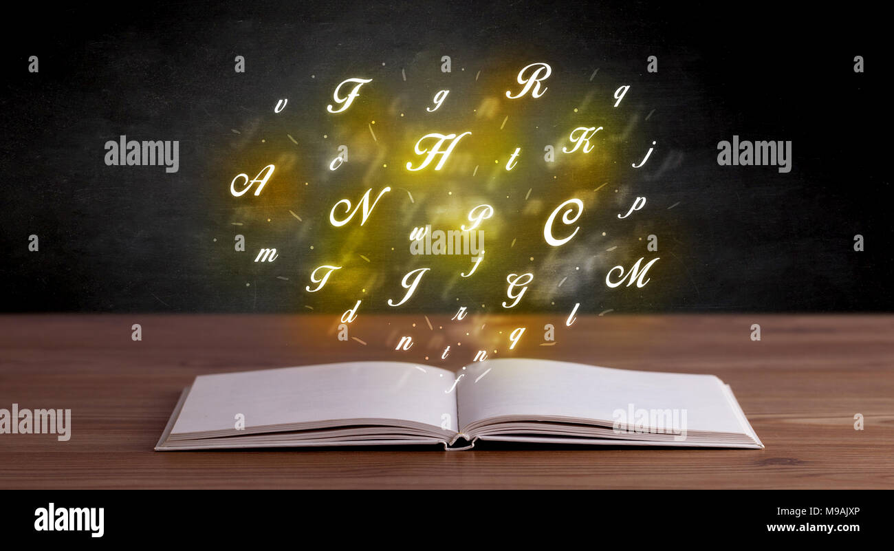 Glowing yellow alphabet letters coming out of an open book Stock Photo ...