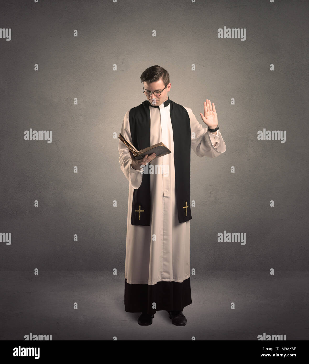 young priest in giving his blessing Stock Photo - Alamy