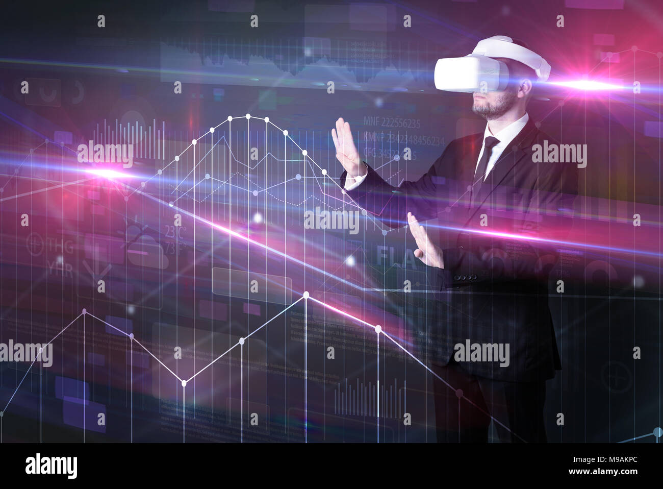 Businessman with virtual reality goggles organizing 3D graphs charts ...