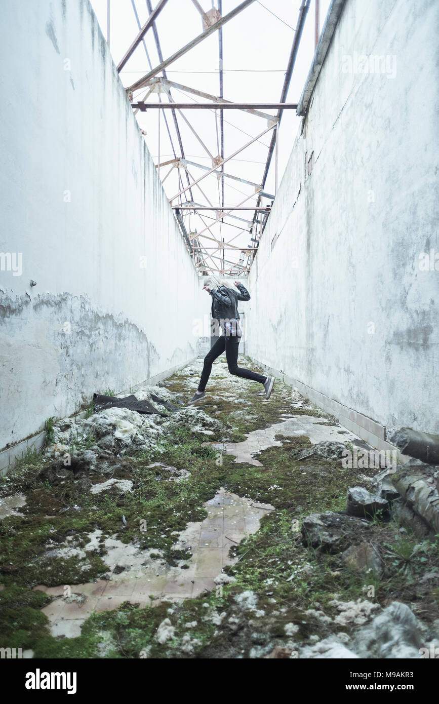 Young woman jumping in strange ruins Stock Photo - Alamy