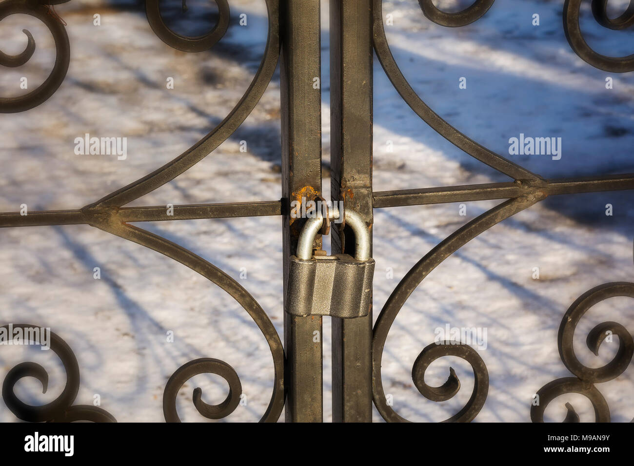Padlock hanging on a decorative metal gate Stock Photo - Alamy