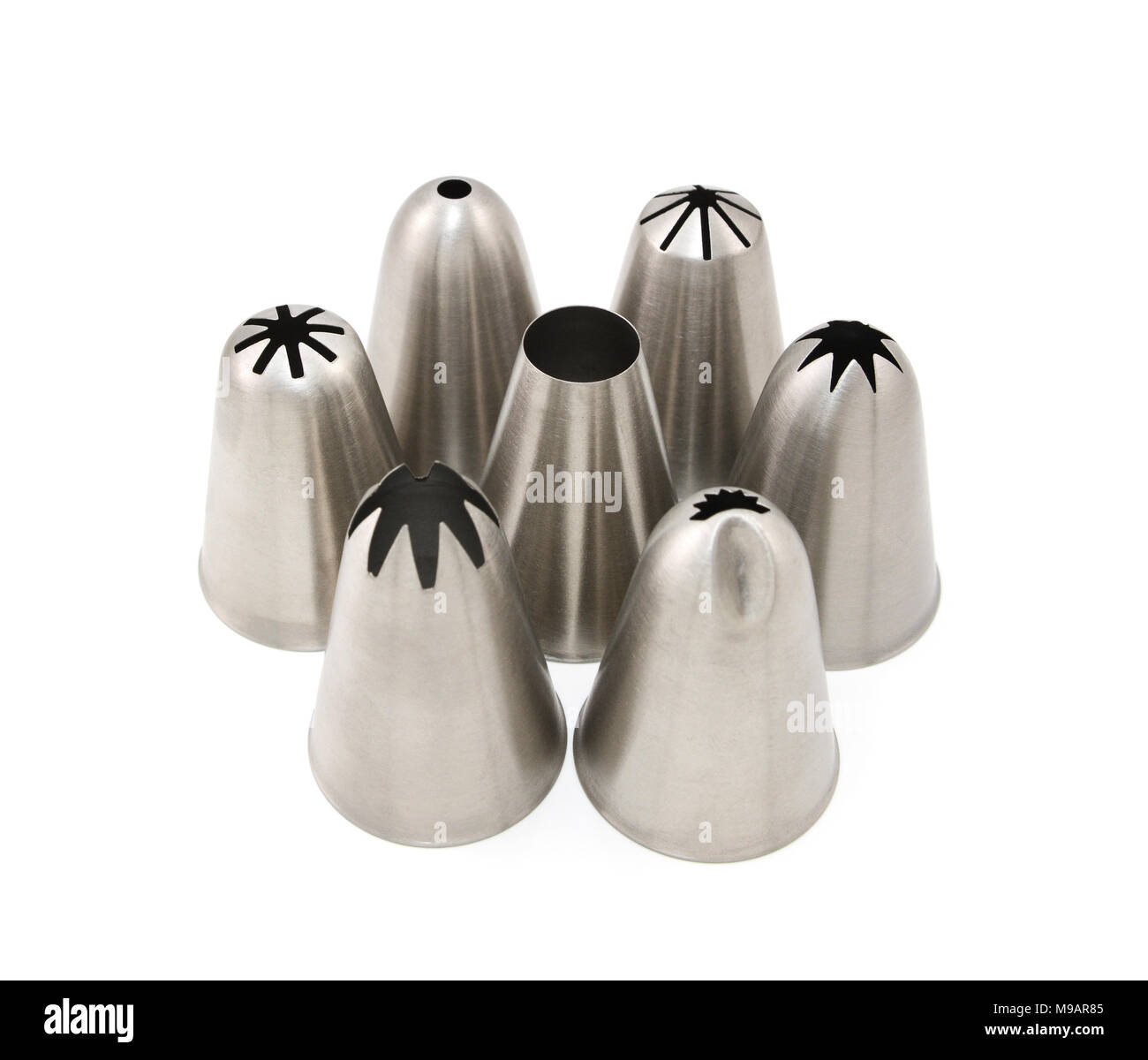 Group of seven metal piping nozzles for frosting, each nozzle has a ...