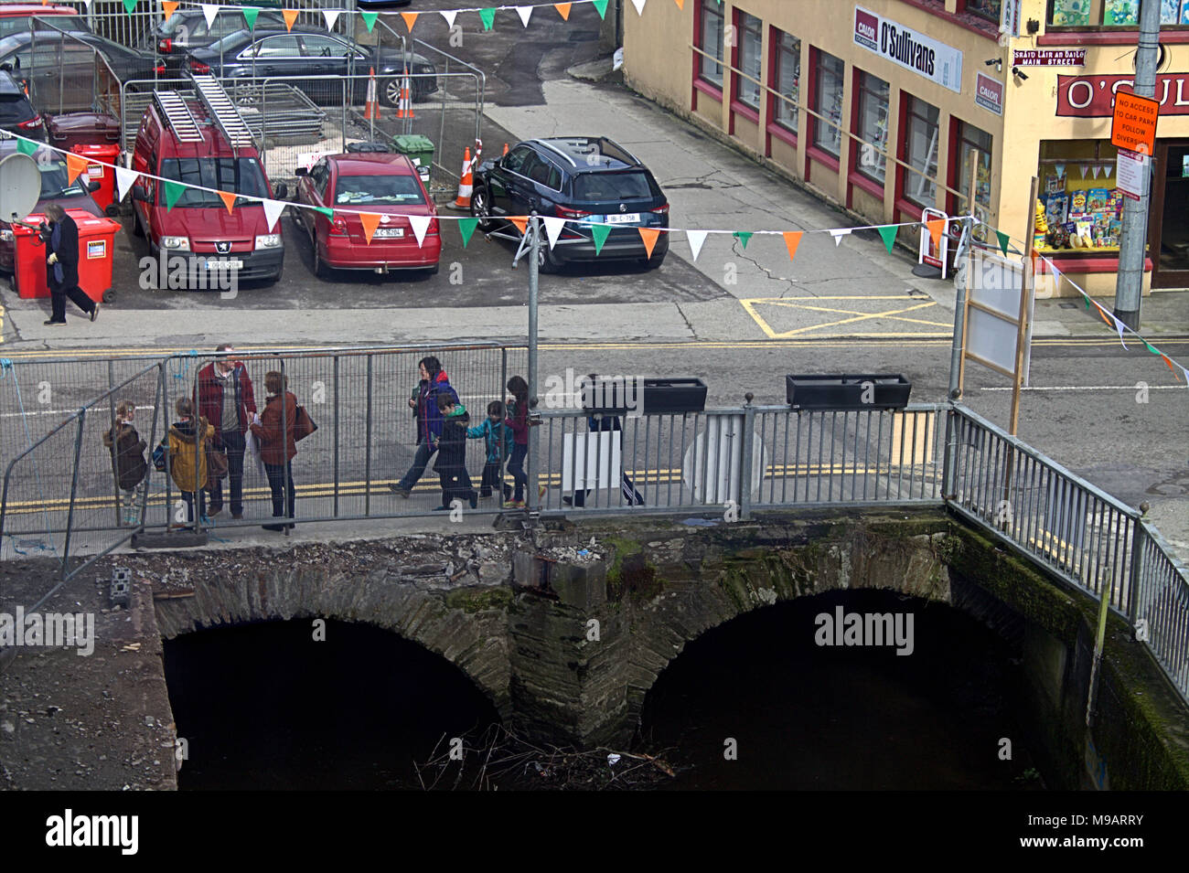 bridge over part of river ilen in skibbereen, ireland, with flags ...