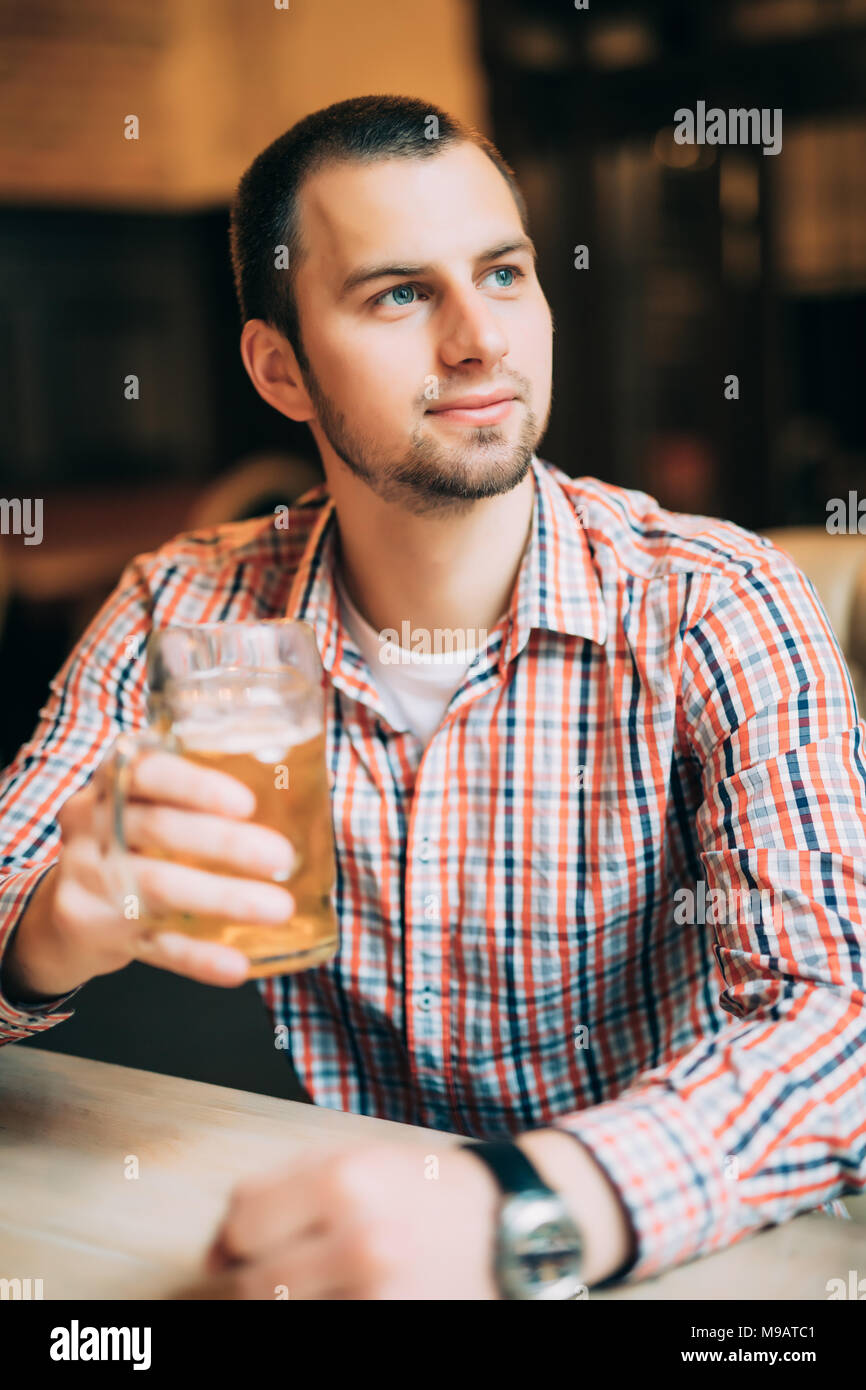 Men drinking beer. Portrait of handsome young men drinking beer Stock ...