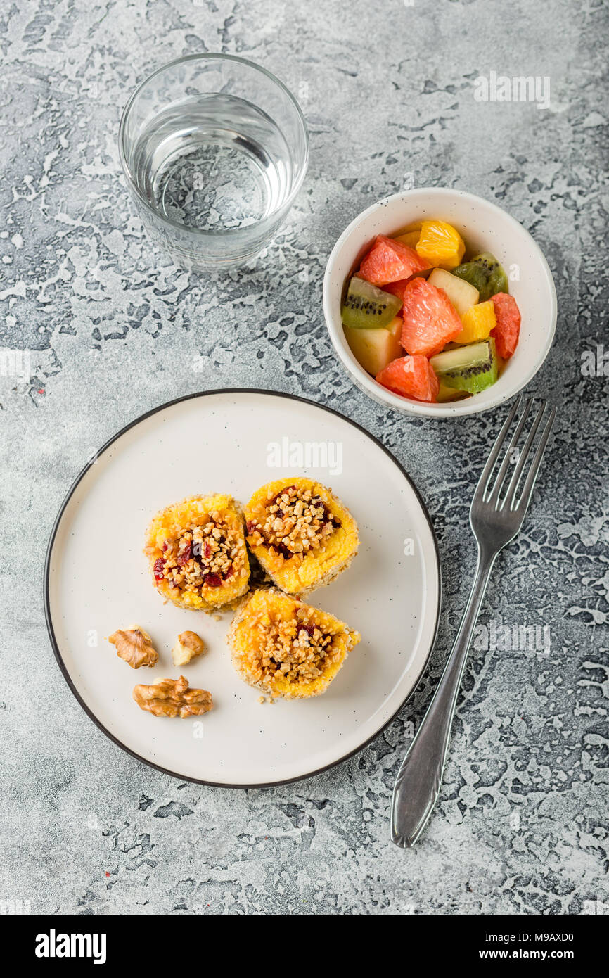 Sweet Rolls of Polenta with dried fruits and nuts on a plate. Top view ...