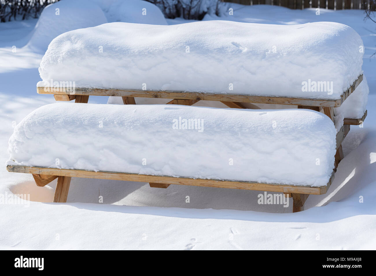Snow covered picnic table Stock Photo - Alamy