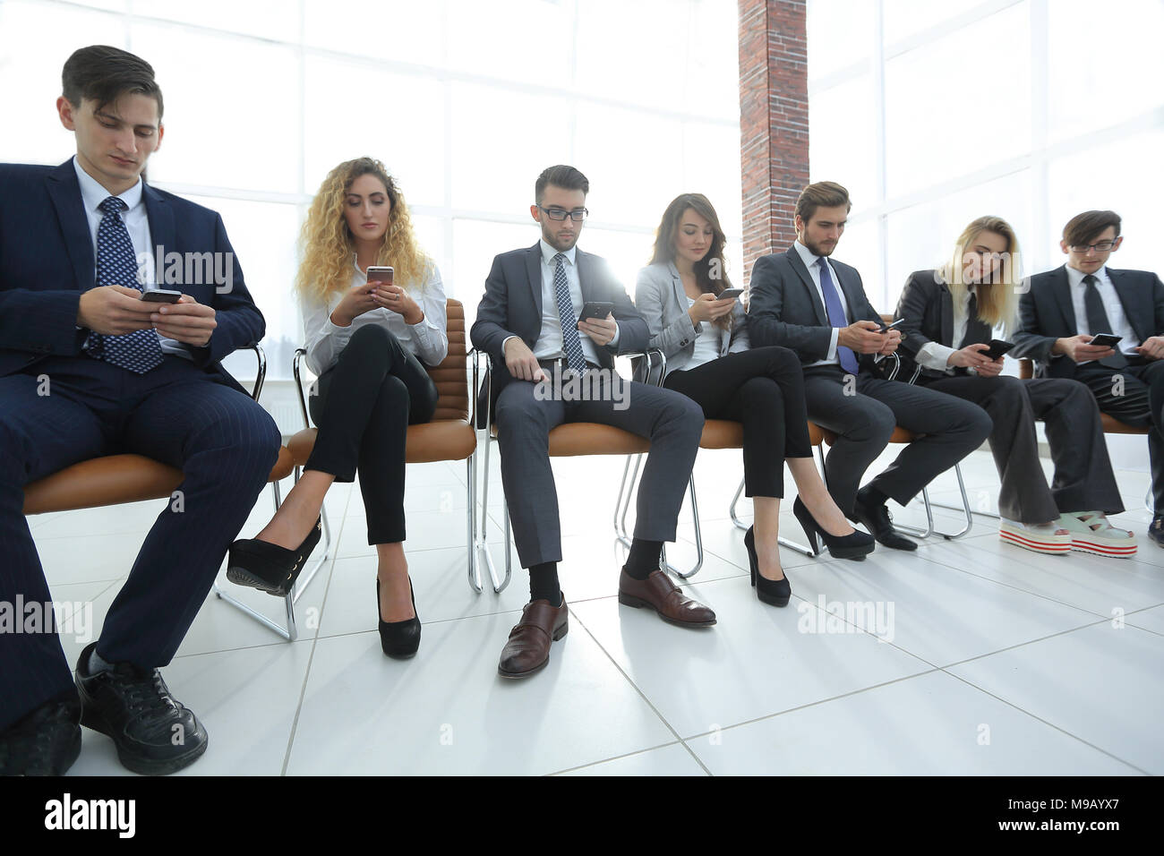 employees using smartphones in the office Stock Photo - Alamy