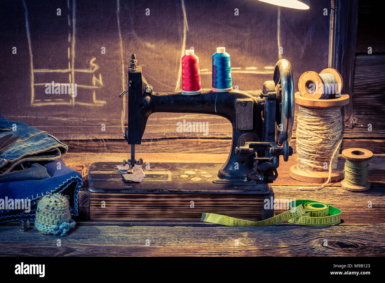 Vintage tailor workshop with scissors, threads and sewing machine Stock ...