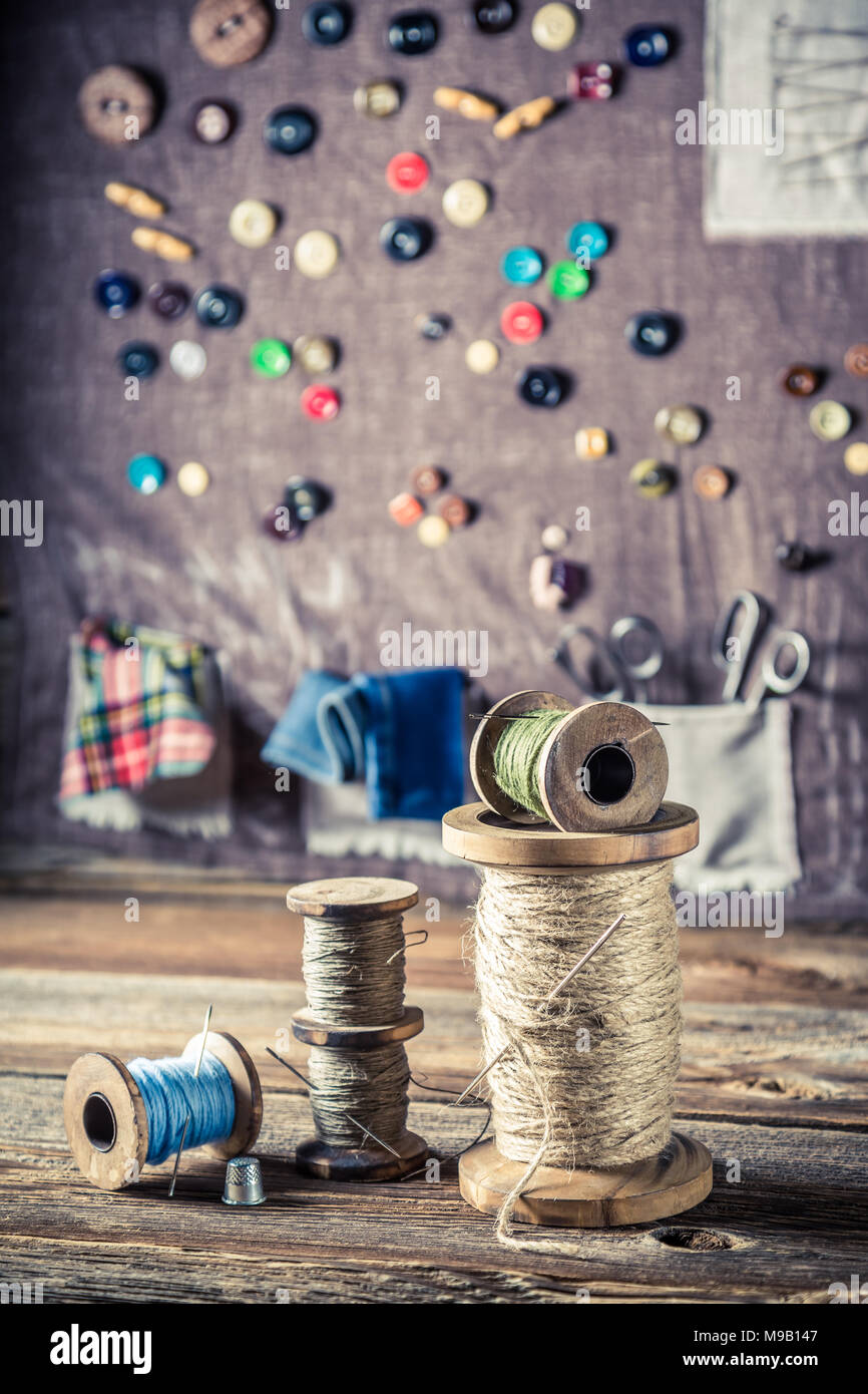 Threads and needles on background with sewing mat Stock Photo - Alamy