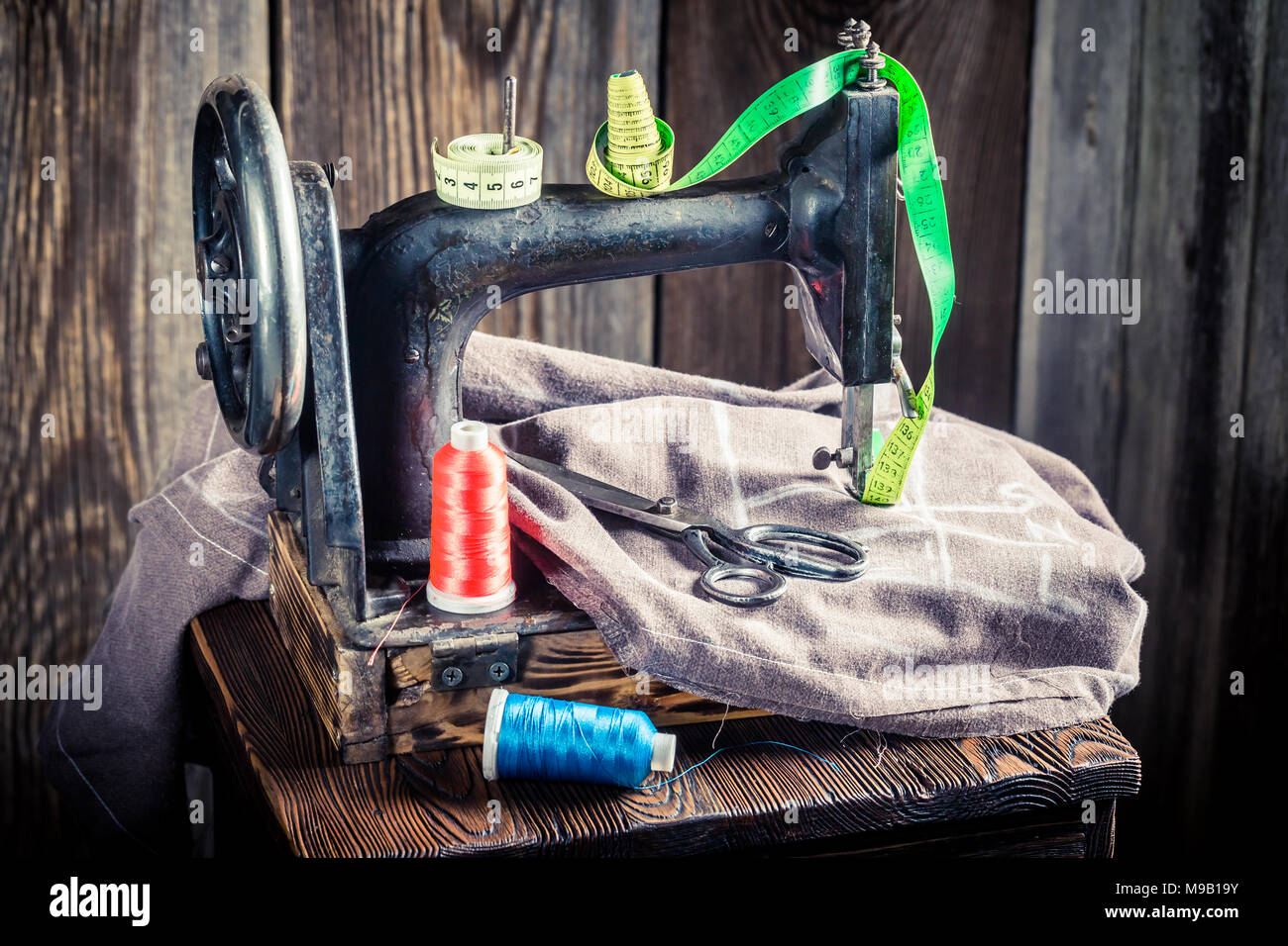 Sewing machine with scissors, colorful threads and cloth Stock Photo ...