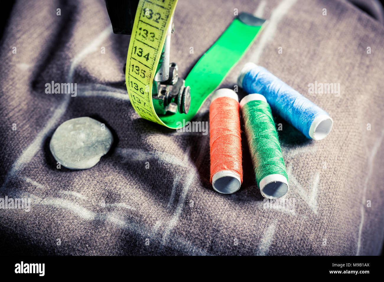 Old sewing machine with needle, tailor tape and threads Stock Photo - Alamy