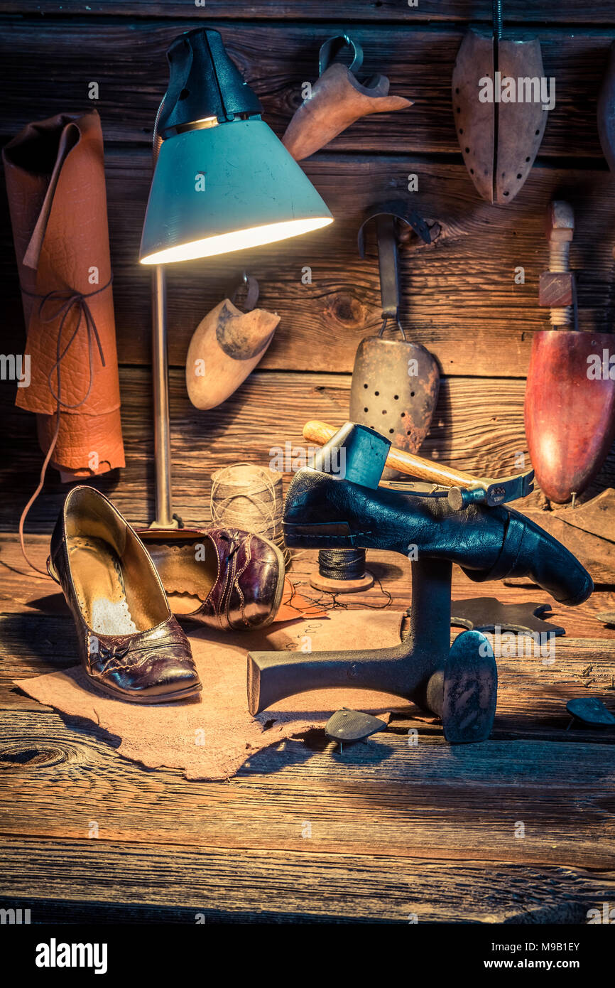 Old shoemaker workplace with tools, shoes to repair Stock Photo - Alamy