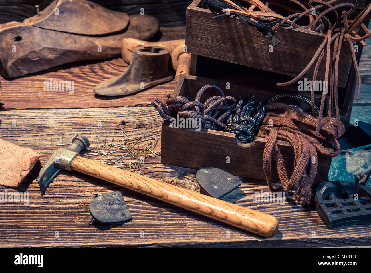 Closeup of vintage cobbler workplace with shoes and tools Stock Photo ...