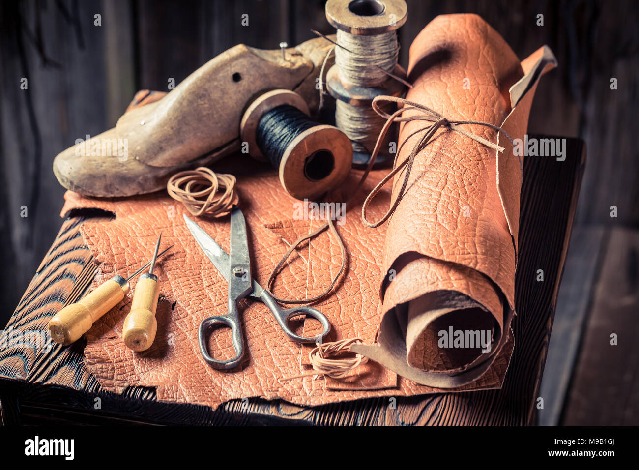 Cobbler workplace with tools, leather and threads Stock Photo - Alamy
