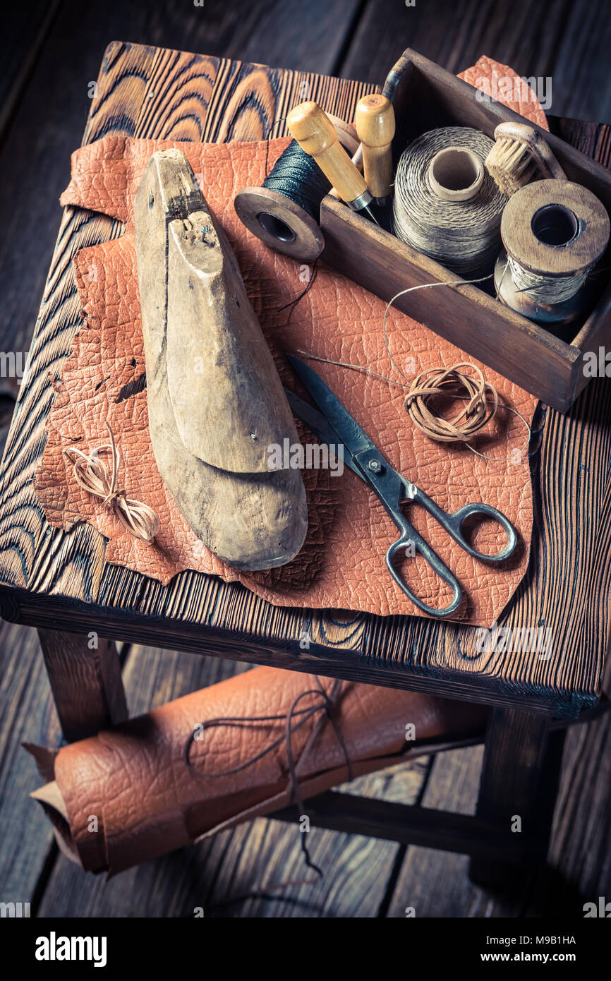 Vintage shoemaker workshop with leather and tools Stock Photo - Alamy
