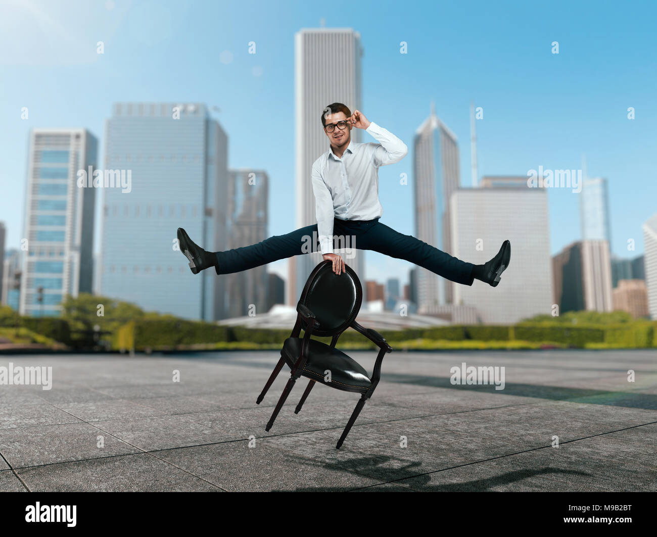 Successful businessman with raised arms against keyhole door in dark ...